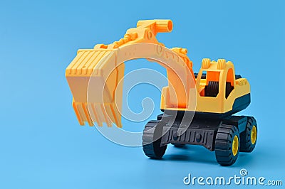 Construction Plastic Backhoe Tractor Toy Isolated On A Blue Background ...