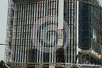 Construction Site, Construction Workers Assembling Scaffolding Of Tall ...