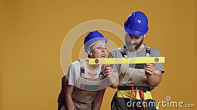Construction Workers Using Water Level Tools To Measure Flat Surface ...