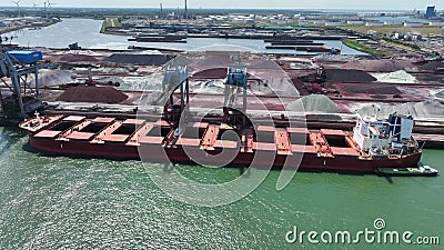 Cranes Unloading Commodities from a Bulk Carrier Ship at Port Stock ...