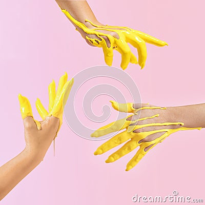 Creative Concept Of A Raised Hands Dipped In Yellow Paint In The Air ...