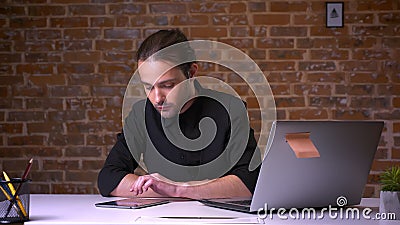 Cute Caucasian Guy Scrolling His Tablet while Sitting at His Working ...