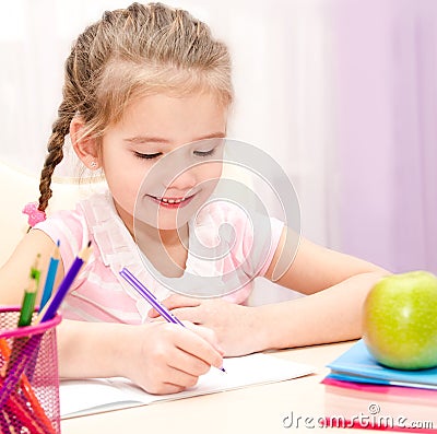 Cute Little Girl Is Writing At The Desk Royalty-Free Stock Image ...