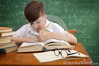 Cute Pupil Writing At Desk Stock Image | CartoonDealer.com #59919409