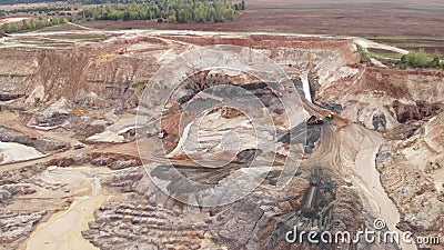 Deep Huge Mining Quarry with Huge Mounds of Minerals. Excavators are ...