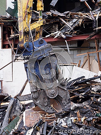 Demolition Claw Removing Debris And Rubble From A Wrecked Building ...