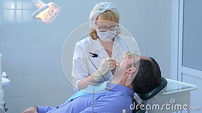 Dentist Examining Patient Gums with Probe Using Method of Computer ...