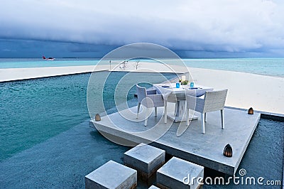 Dining Table On The Deck Of Swimming Pool Stock Photos - Image: 16405503