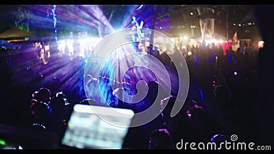 DJ Playing in a Large Trance Party with Large Crowd of People Dancing ...