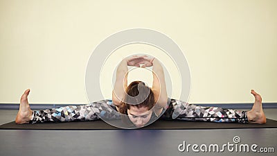 Doing Back Twists in Leg-split Position. Practising Yoga Asanas. Stock ...