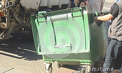 Dustman Worker Is Moving Empty Garbage Container From Truck Royalty ...