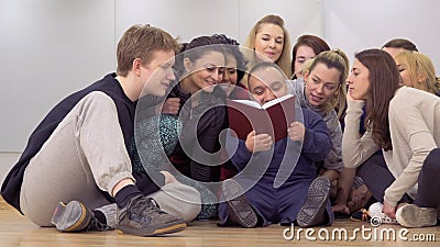 The Dwarf Reading the Book and Sits among the Friends on Floor Stock ...