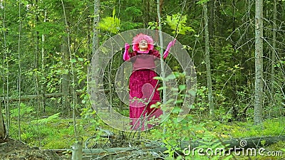 An Eerie Witch in Ritual Clothes in the Forest Performs a Ritual Dance ...