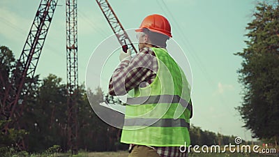 Electrical Engineer Wearing Hard Hat and Safety Vest Checking ...