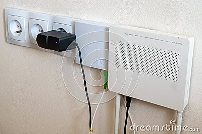 Electrical Outlets And Internet Modem On A Cream Wall Background Stock ...