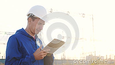 Electrical Worker Engineer a Working with Digital Tablet, Near Tower ...