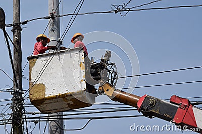 Electrical Workers On Telehandler With Bucket Installing High Tension ...