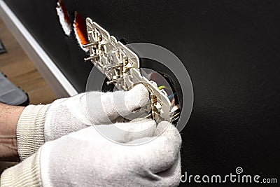 An Electrician Inserts A Double Grounded Electrical Socket Into An ...