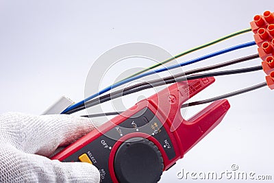 The Electrician Measures The Current In The Phase Wire With A Meter ...