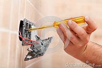 Electrician Testing For Electricity In Electrical Wall Fixture Stock ...