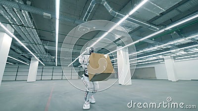 Empty Storage Unit with a Robot Lifting a Carton Box and Carrying it ...