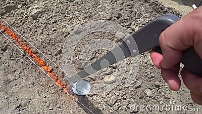 An Engineer Builder Makes a Marking with Orange Paint on a Construction ...