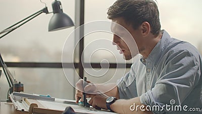 Engineer Draws Buildings on the Table Using a Pencil and Ruler. an ...
