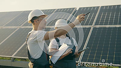 An Engineer and His Assistant Check the Operation of Solar Panels Stock ...