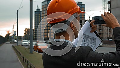 Engineer with the Smart Phone Taking Pictures of Construction Stock ...