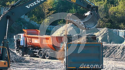 The Excavator Loading Crushed Stone into a Dump Truck in a Crushed ...