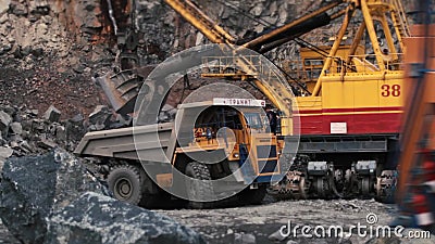 Excavator Loads a Stone in the Heavy Truck in the Quarry Mining Granite ...