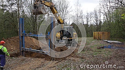 The Excavator Operator Installs First Structure Consisting of Two ...