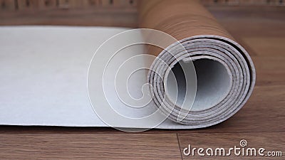 An Expanded Roll of Brown Linoleum Lies on the Floor. Linoleum with ...