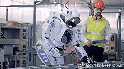 A Factory Worker Switches on a Droid, Controlling it. Stock Video ...