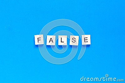 FALSE Word Alphabet Letters On Blue Background. Top View. Flat Layout ...