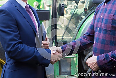 Farmer And Businessman Shaking Hands With Tractor In Background Royalty ...
