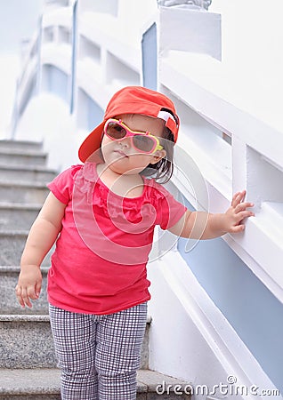 A Fat Baby Posing For The Camera While Working Down Stairs Stock ...