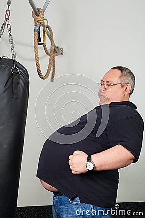 Fat Man Match Belly With A Punching Bag Stock Photo - Image: 65264586