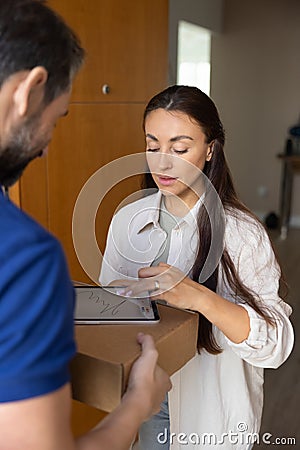 Female Customer Getting Parcel From Courier, Touching Digital Gadget Screen Royalty-Free Stock ...