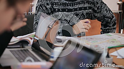 A Few People Sitting at the Table on Which Lay Some Maps, and Work with ...