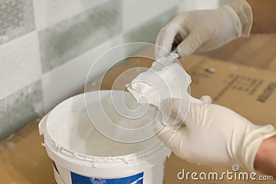 Final Finishing Work With Laying Of Ceramic Tiles. Close-up Of Hands ...