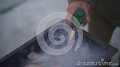 Fire in the Brazier. a Hand in a Red Checked Shirt and Black Glove ...