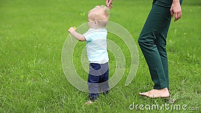 First Steps Baby Boy with Help Mother. Slow Motion Stock Video - Video ...