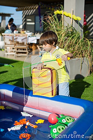 Fishing In The Paddling Pool. The Children Are Playing. Royalty-Free ...