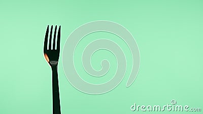 Flame Gas Lighter Burns Black Disposable Plastic Fork on Green Screen ...
