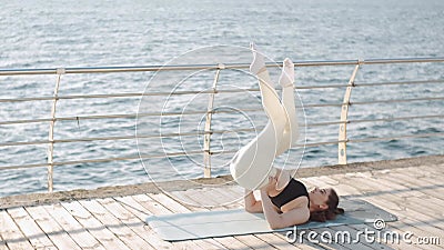 Flexible Female Gymnast Doing Acrobatic Tricks at Sunrise on the Beach ...