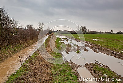 Flooded And Deeply Rutted Field Track Alongside A Swollen River. Stock ...
