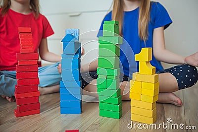 Four Towers Of Colored Cubes Close-up. Children In The Background ...