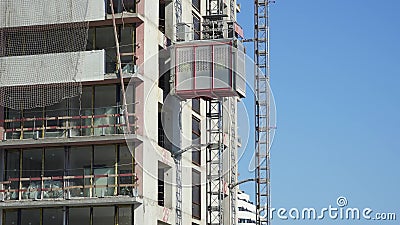 Freight Elevator at the Construction Site of a Tall Building Rides Up ...