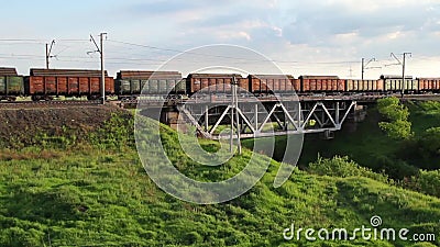 Freight Train Passing Over the Railway Bridge at Sunset Stock Video ...